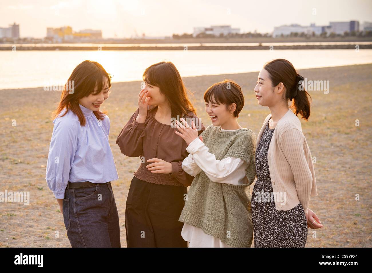 Four asian young women talking happily in the dusk Stock Photo - Alamy