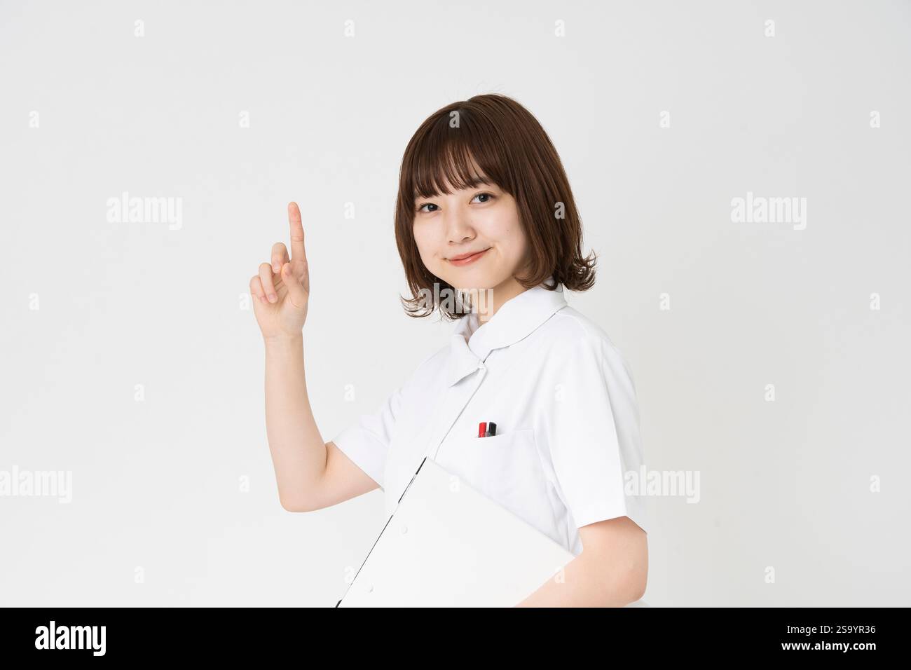 Nurse pointing upwards Stock Photo - Alamy