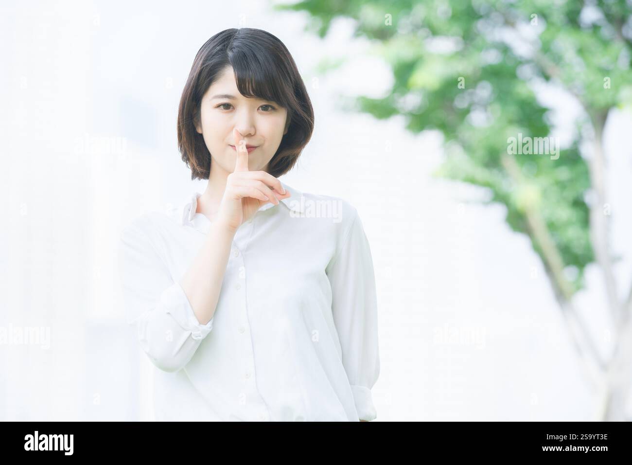Young woman making the ‘secret’ hand sign Stock Photo - Alamy