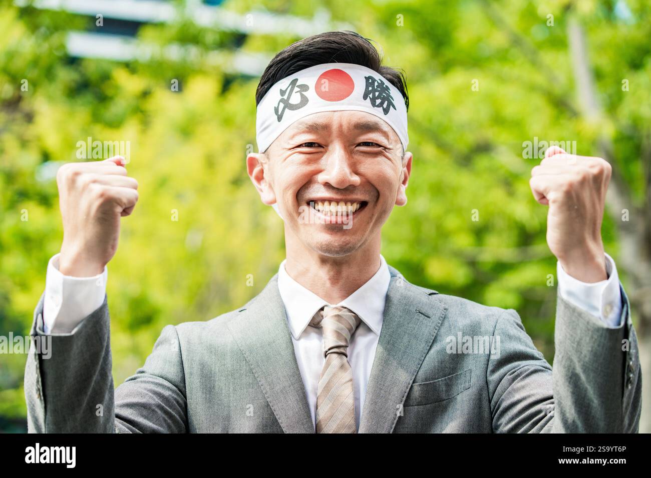 A man posing with a ‘must-win’ headband Stock Photo - Alamy