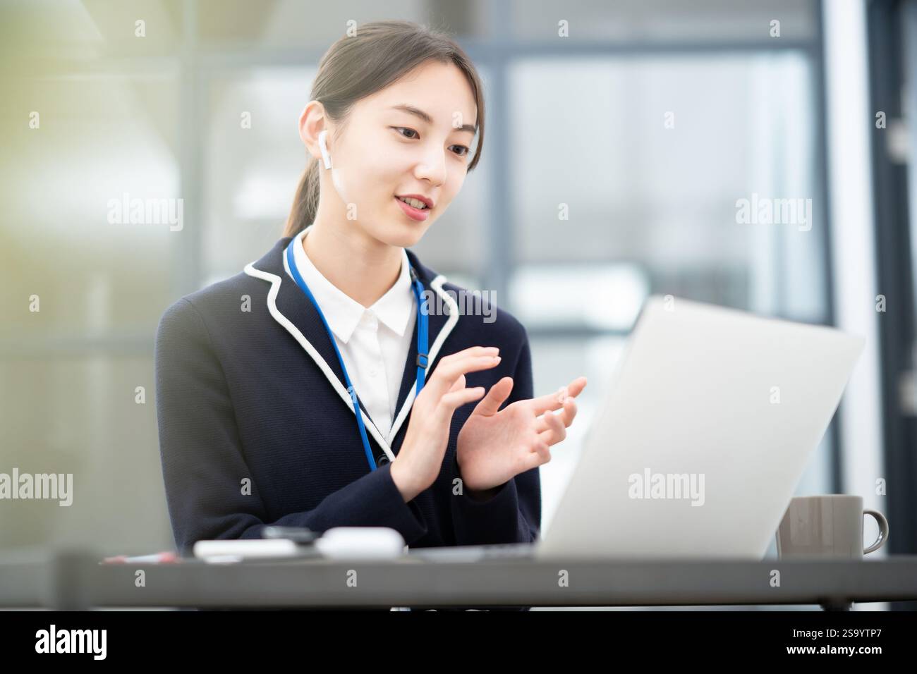 Woman talking towards computer screen Stock Photo - Alamy
