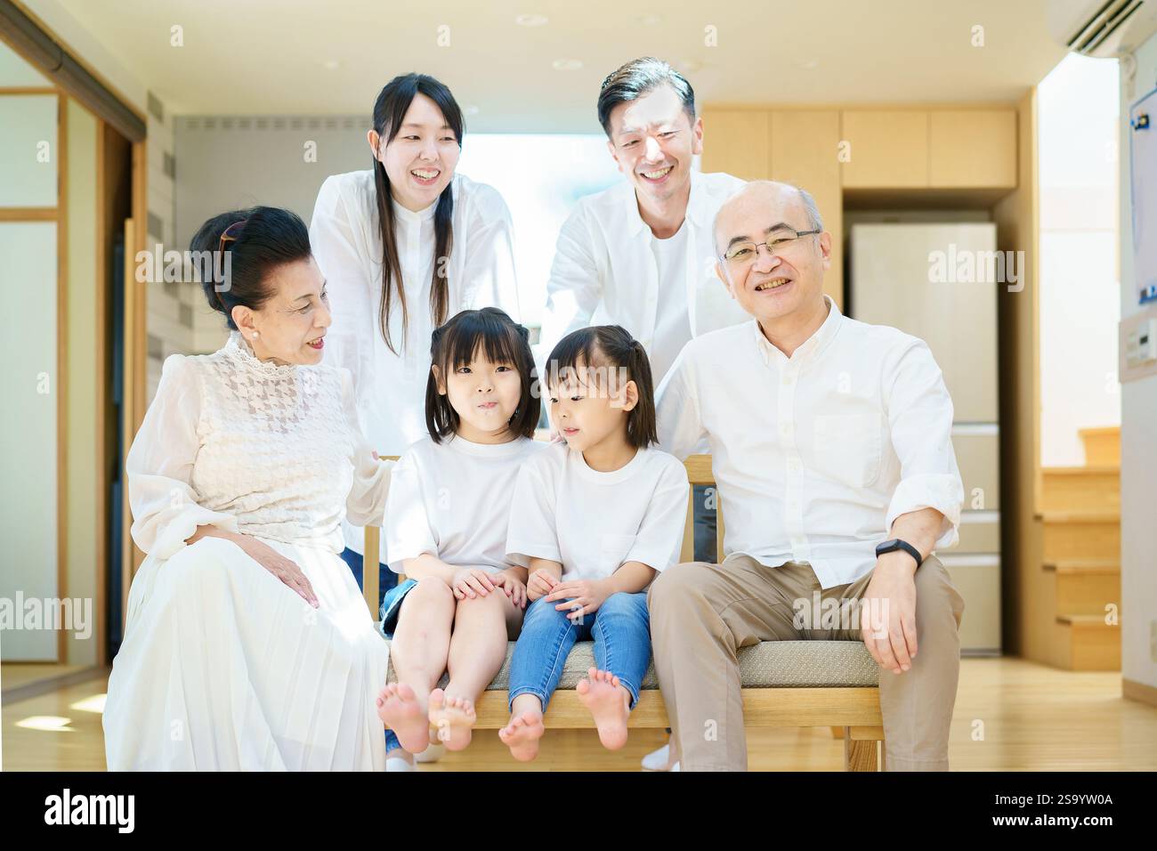 Three-generation family gathered in the living room Stock Photo - Alamy