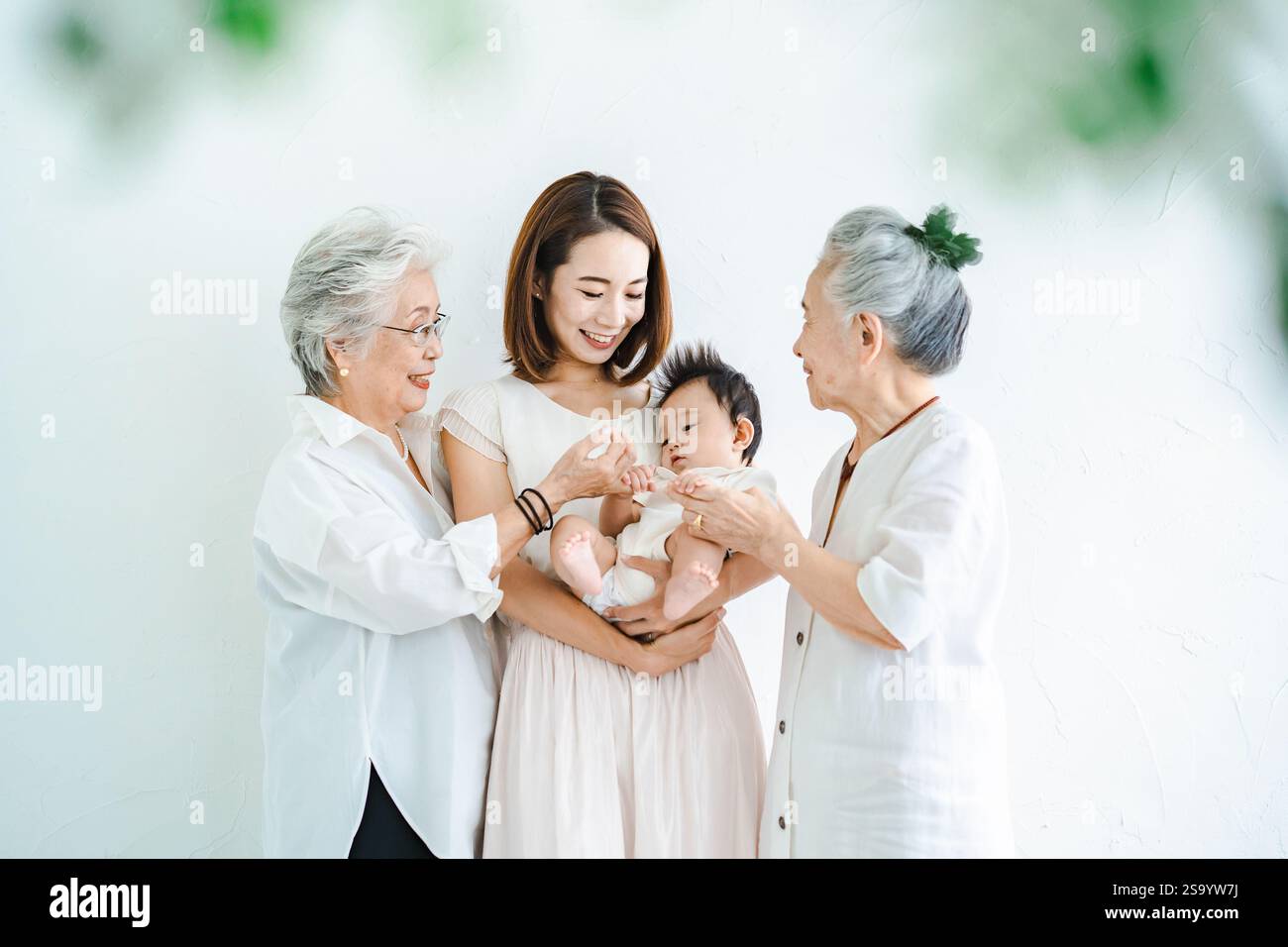 Mother carrying baby and two senior women Stock Photo - Alamy