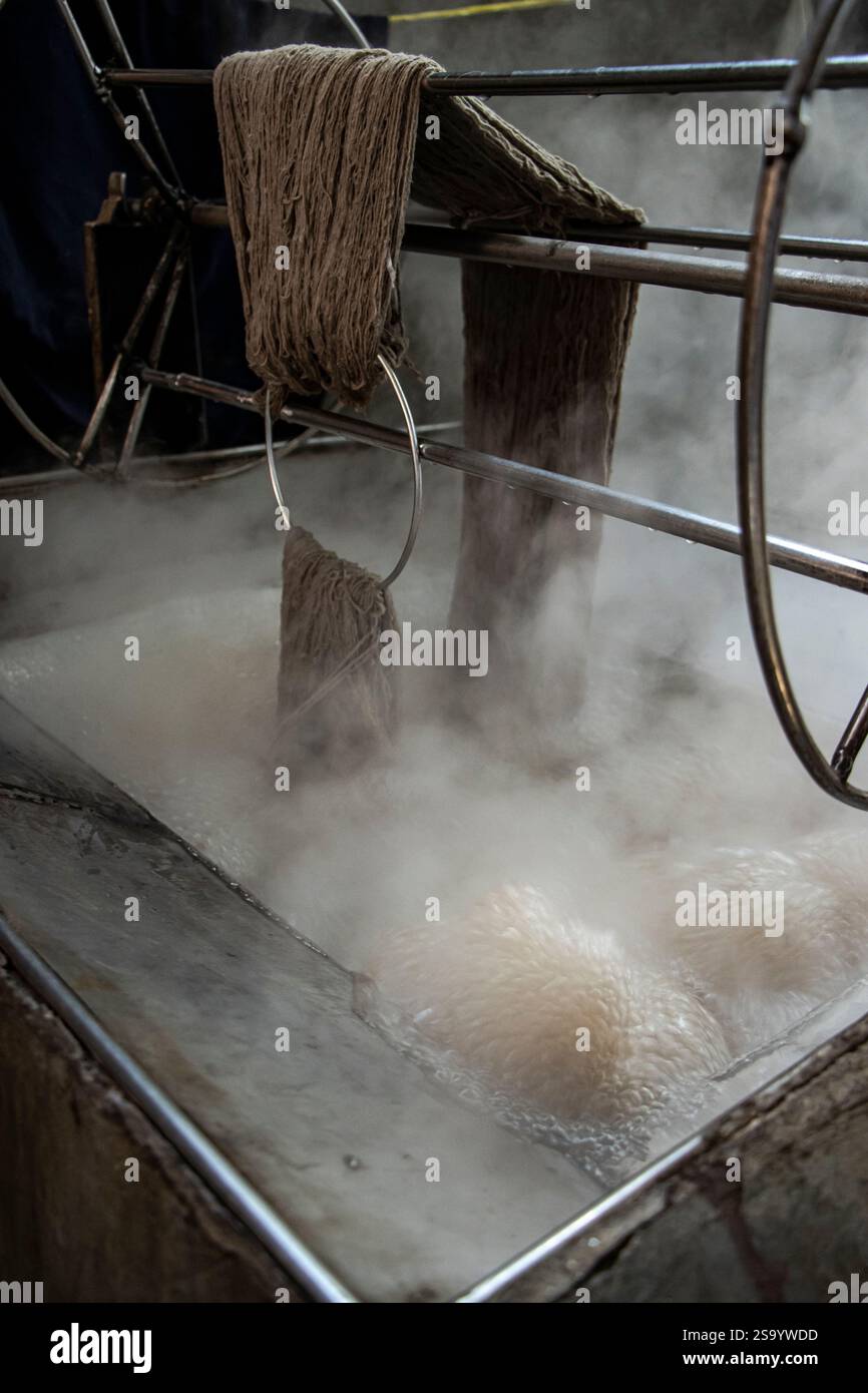 Workers with precision and care, skillfully wrap skeins of yarn around ...