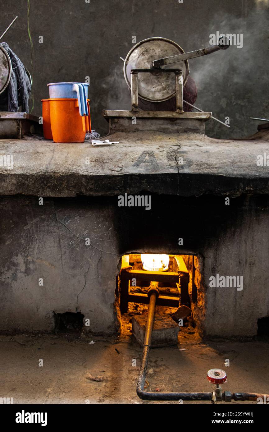 A row of stoves and burners at a carpet factory in Bouddha, diligently ...