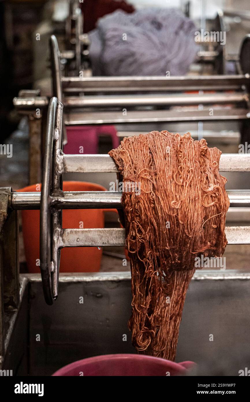 Workers with precision and care, skillfully wrap skeins of yarn around ...