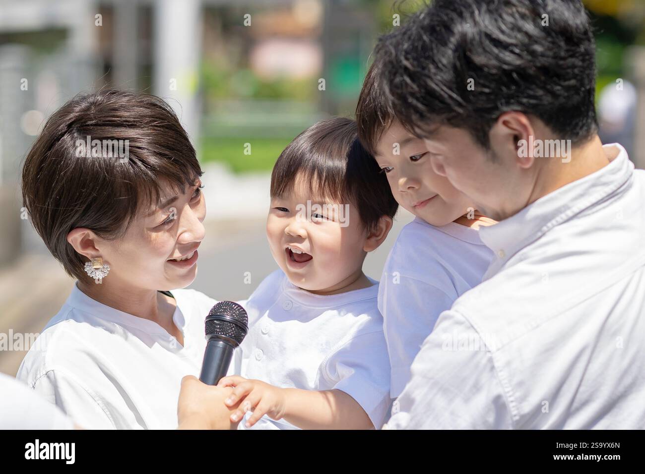 Family being interviewed on the street Stock Photo - Alamy