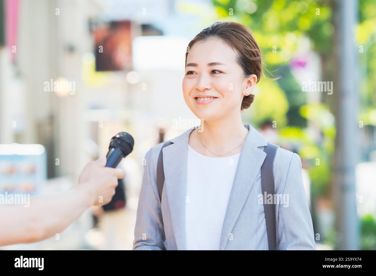 Business woman interviewed on the street of Tokyo Stock Photo - Alamy