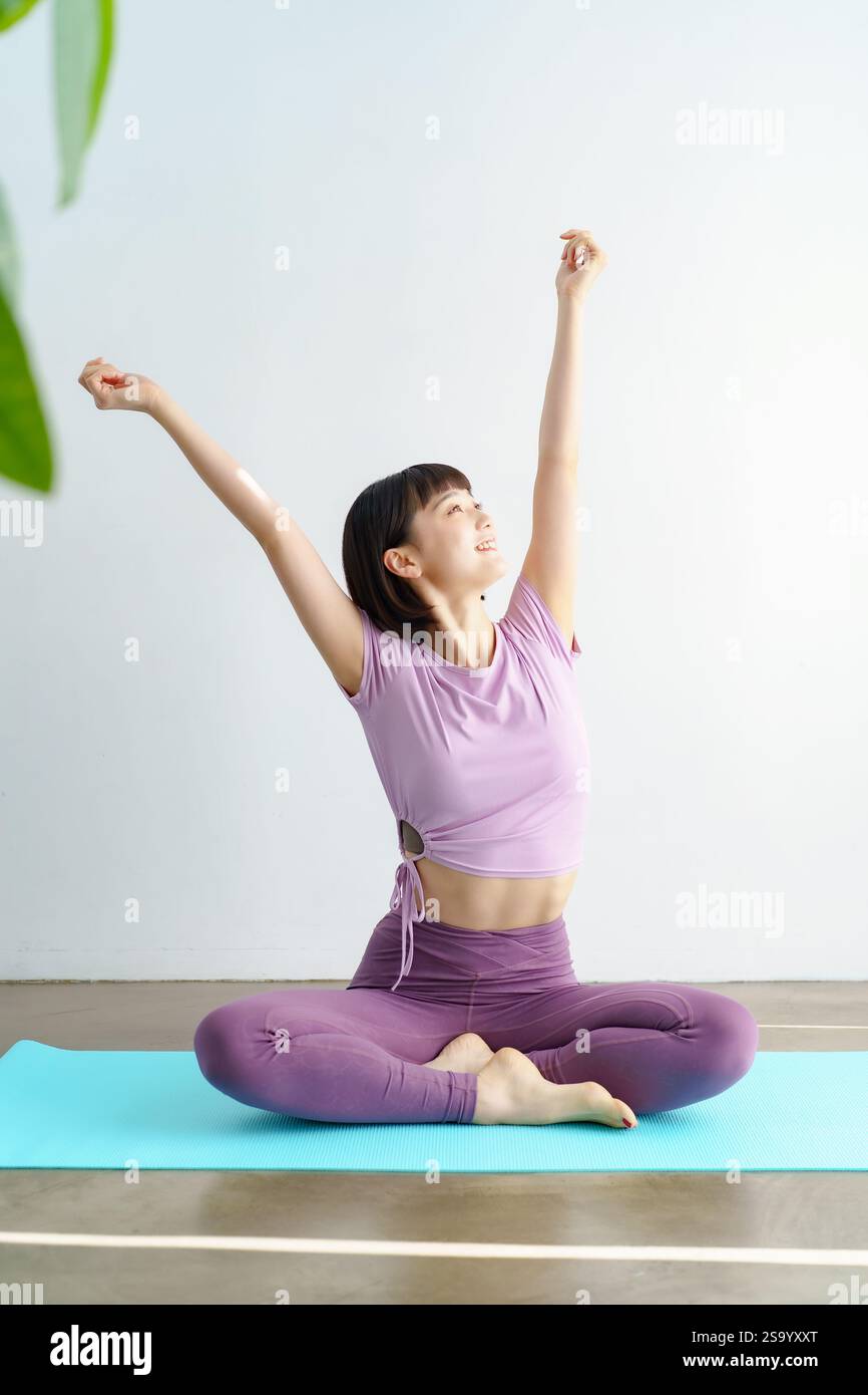 Woman taking deep breaths between yoga poses Stock Photo - Alamy