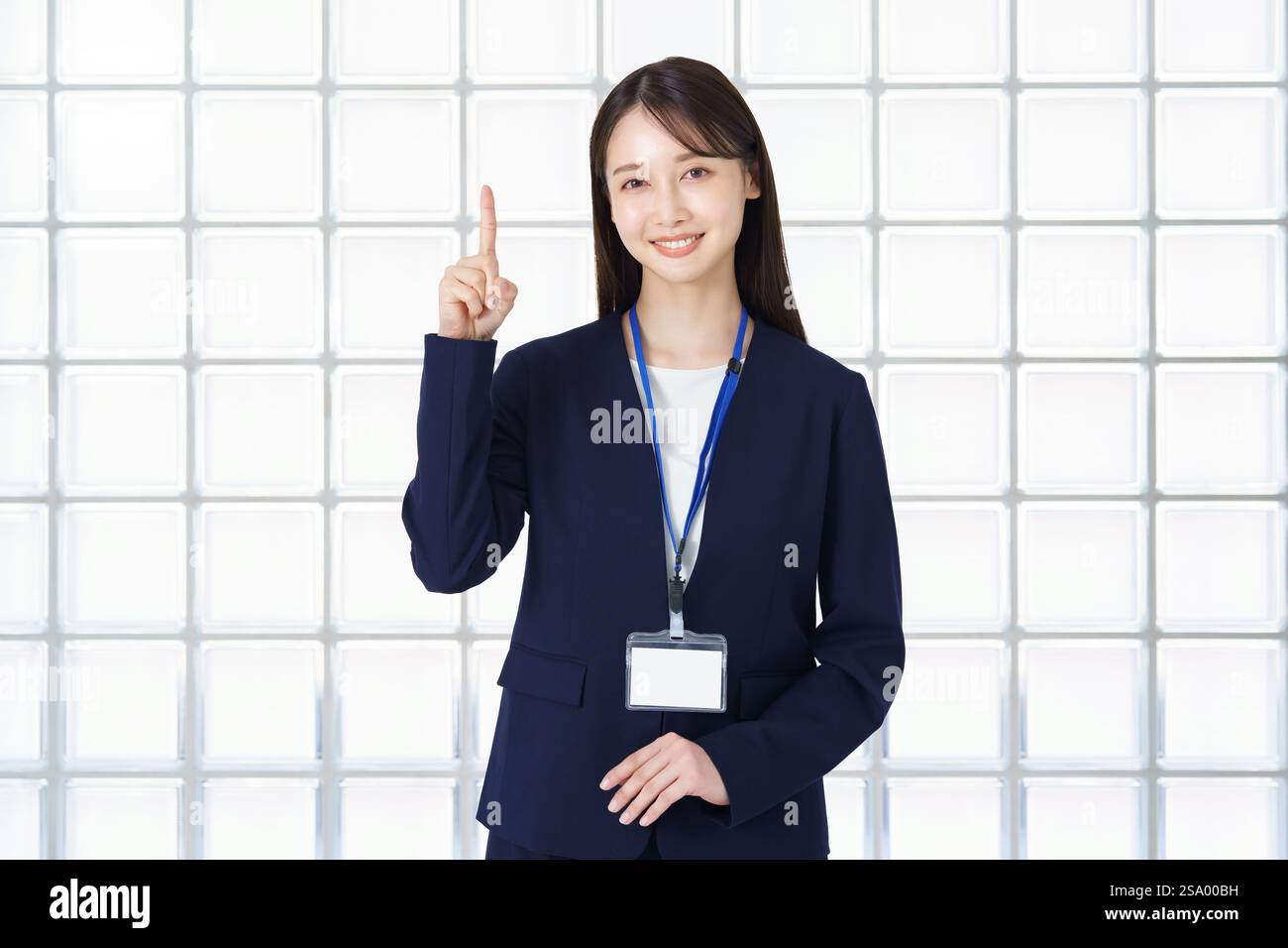 Woman in suit striking a pointing pose Stock Photo - Alamy