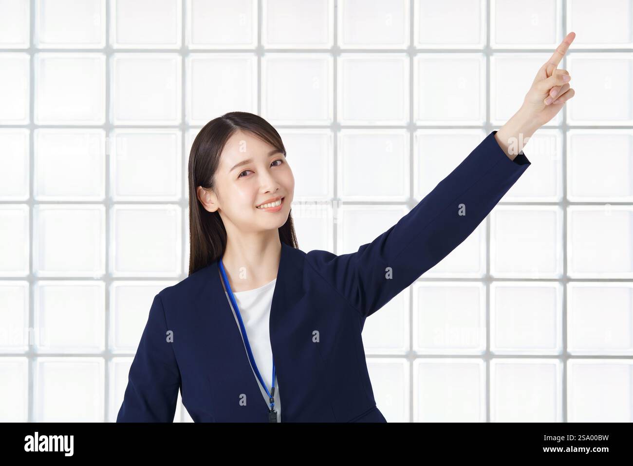 Woman in suit striking a pointing pose Stock Photo - Alamy