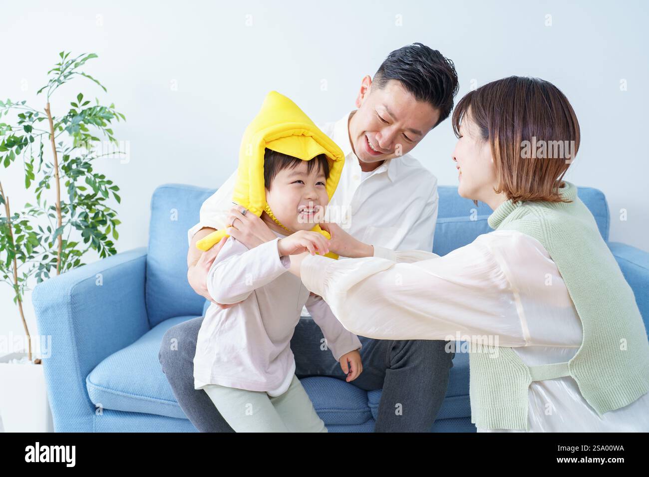 Child wearing disaster prevention hood Stock Photo - Alamy