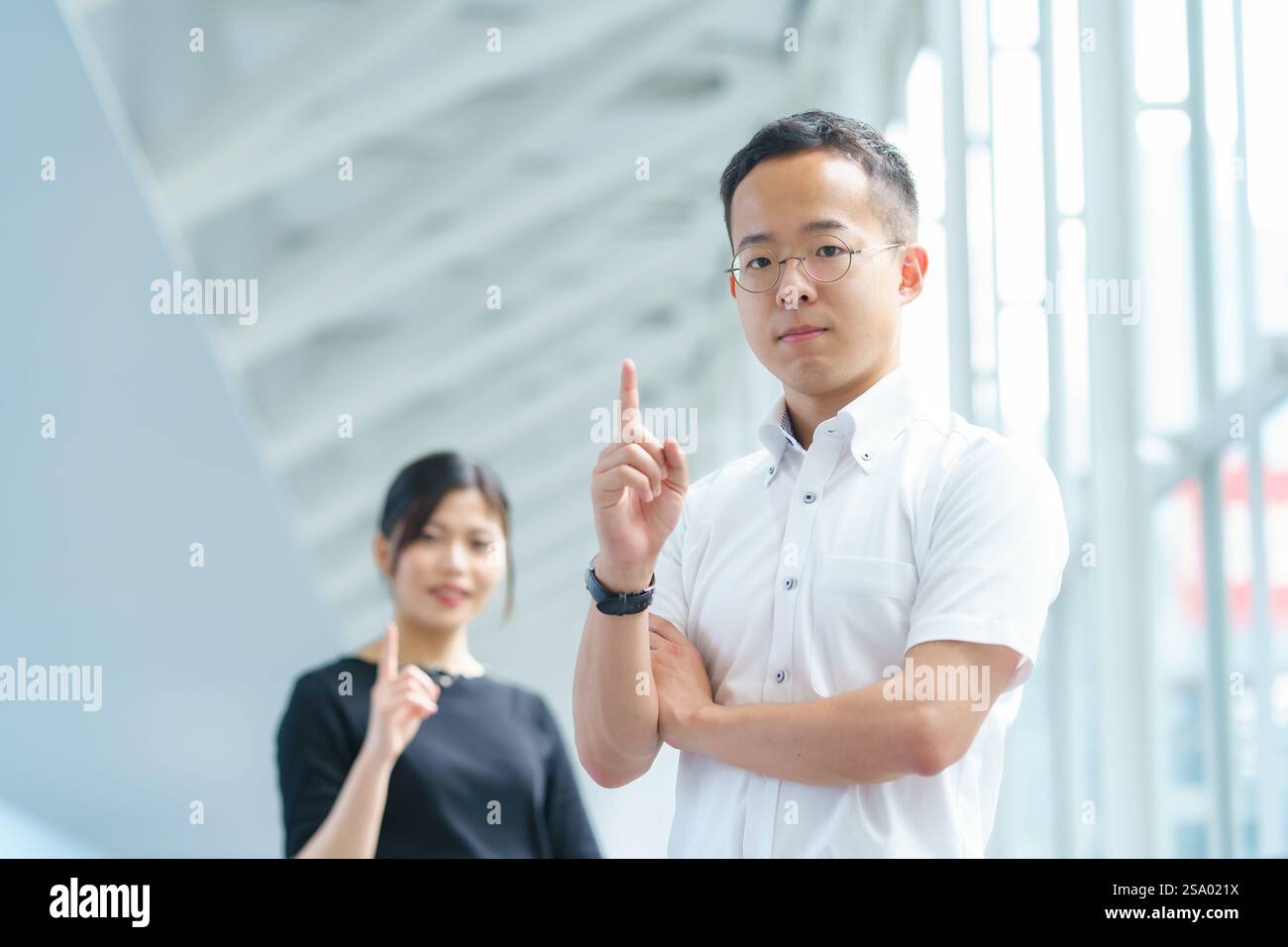 Businessperson raising index finger Stock Photo - Alamy