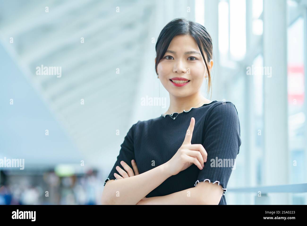 Businesswoman raising index finger Stock Photo - Alamy