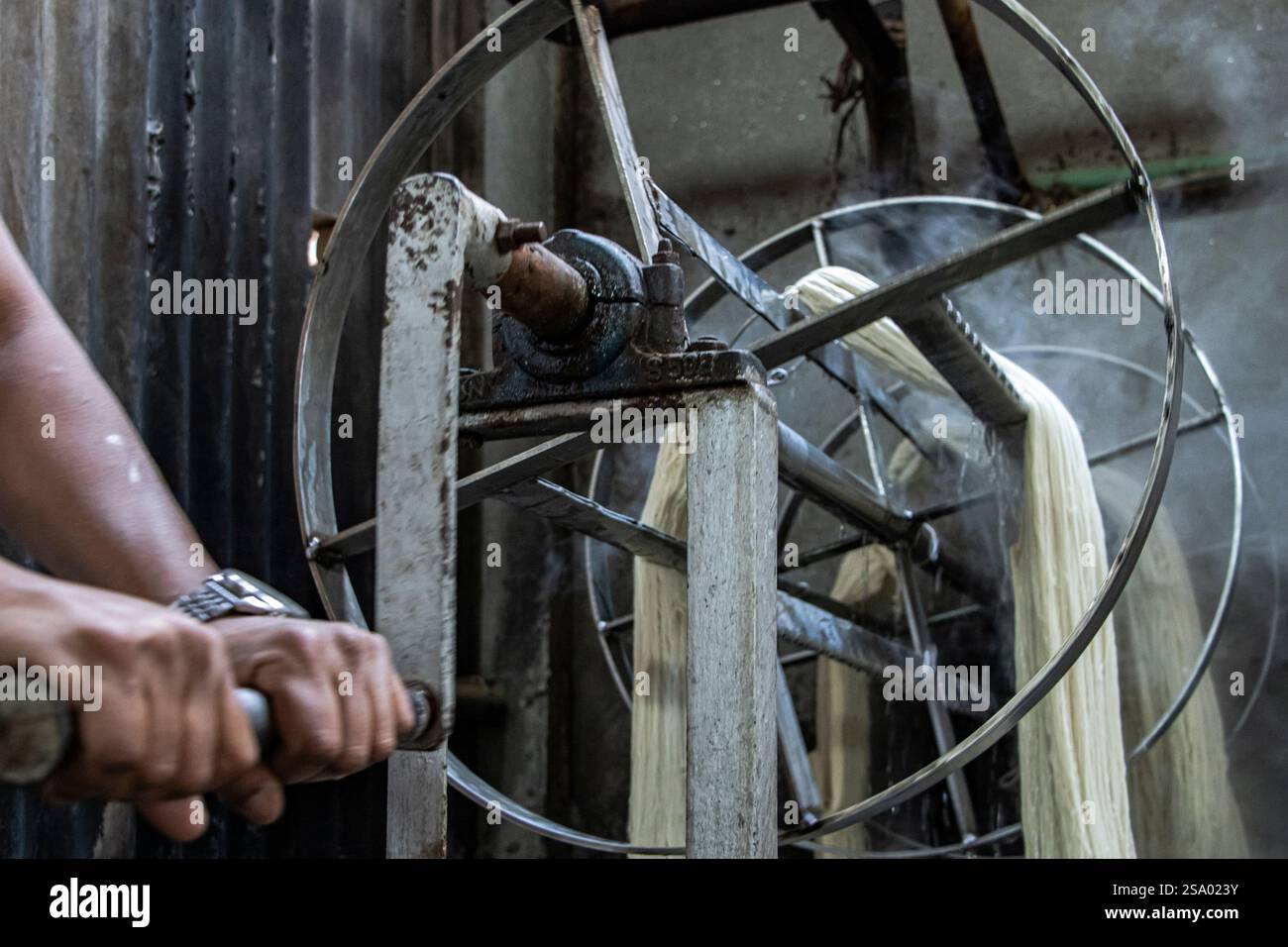 Workers with precision and care, skillfully wrap skeins of yarn around ...
