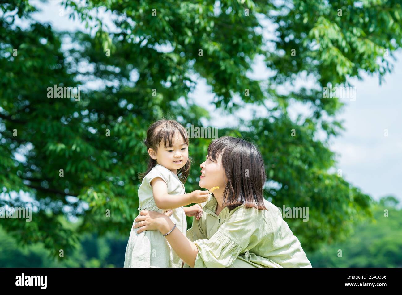 Parent and child hugging in the park Stock Photo - Alamy