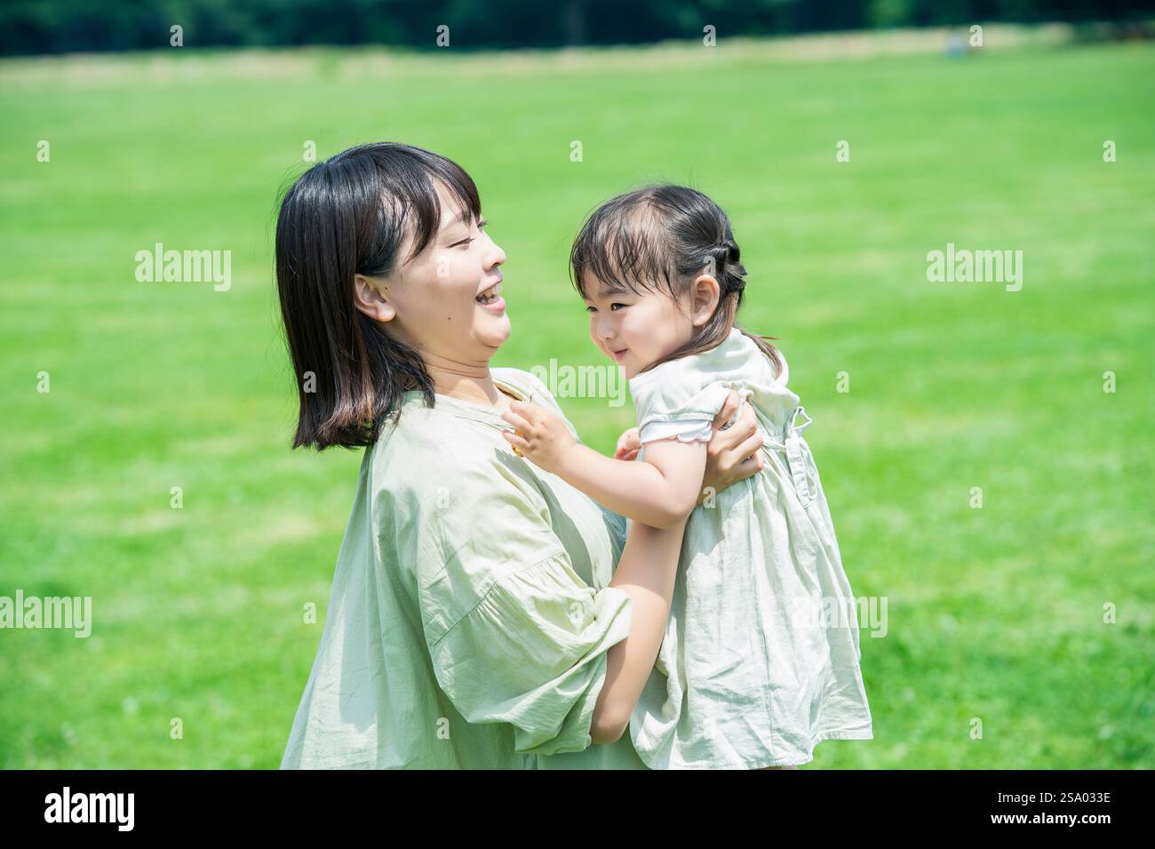 Parent and child hugging in the park Stock Photo - Alamy