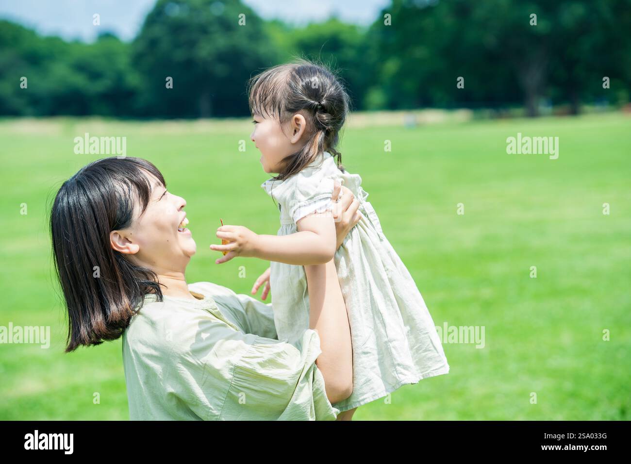 Parent and child hugging in the park Stock Photo - Alamy