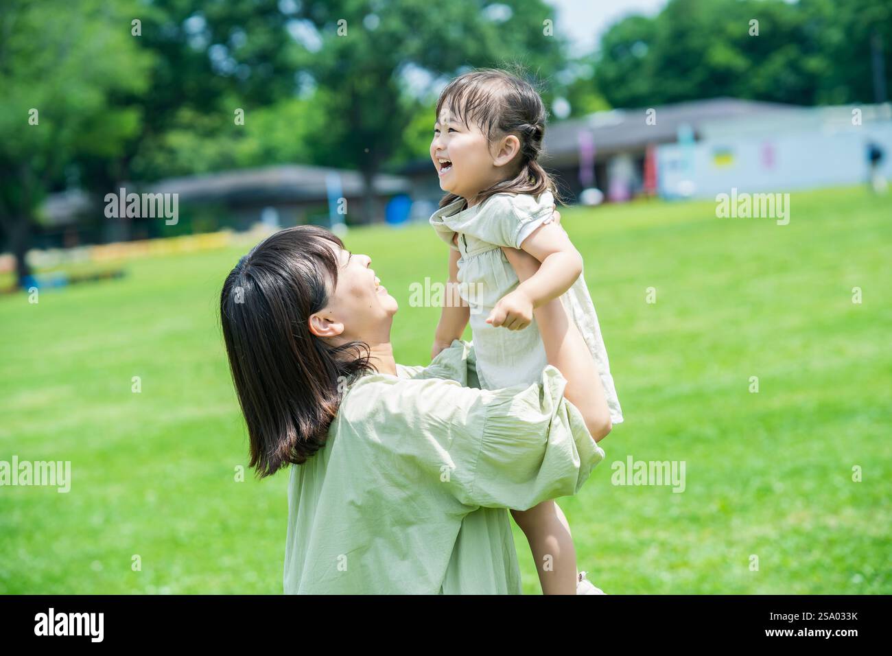 Parent and child hugging in the park Stock Photo - Alamy