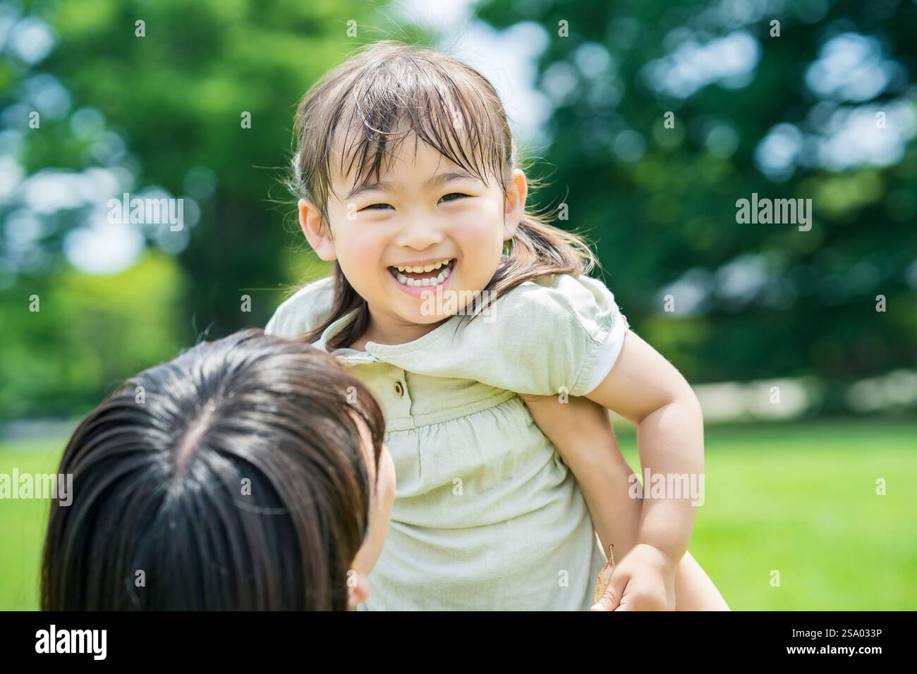 Parent and child hugging in the park Stock Photo - Alamy