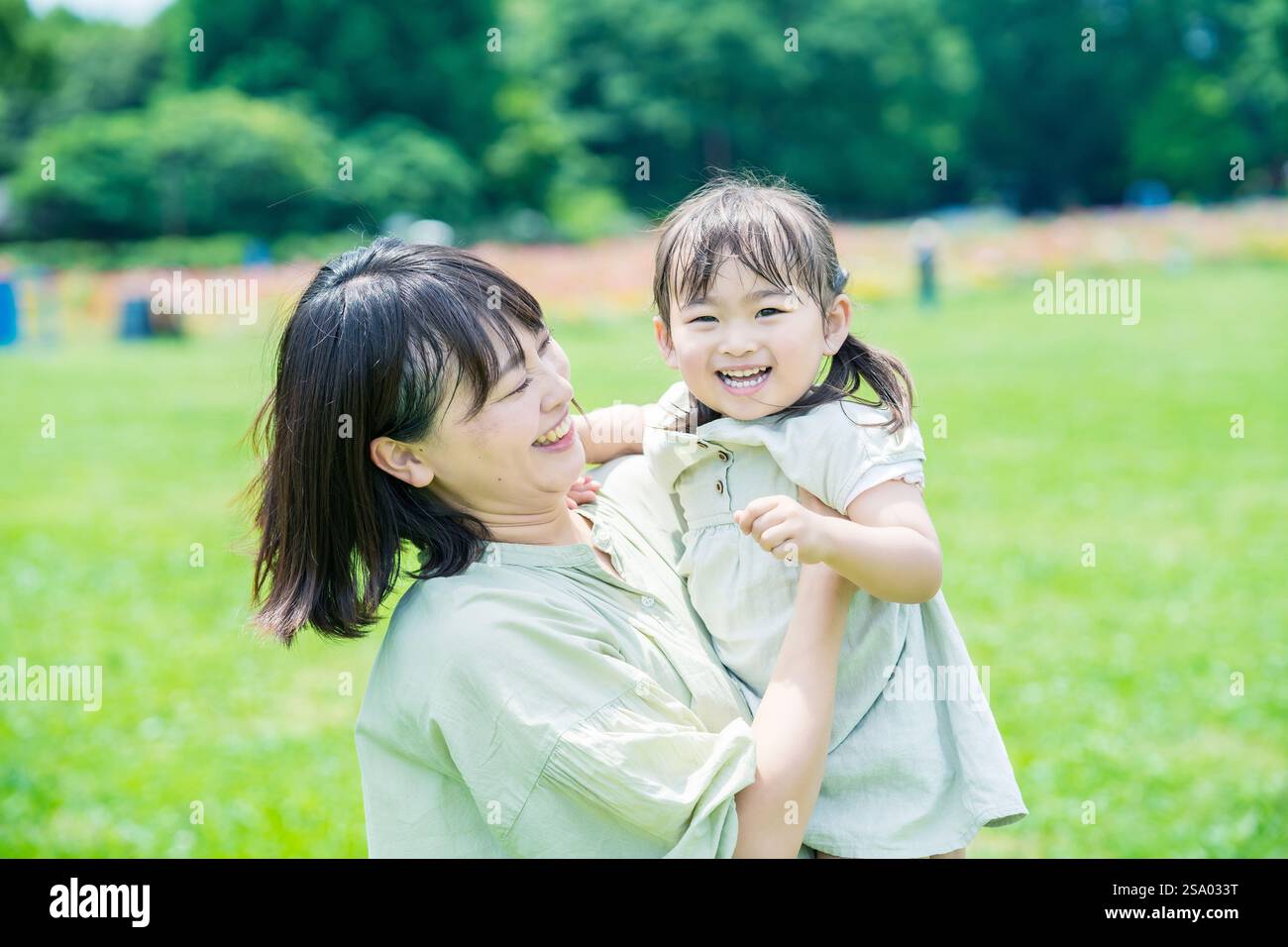 Parent and child hugging in the park Stock Photo - Alamy