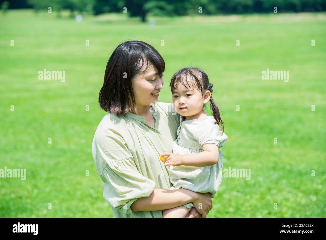 Parent and child hugging in the park Stock Photo - Alamy