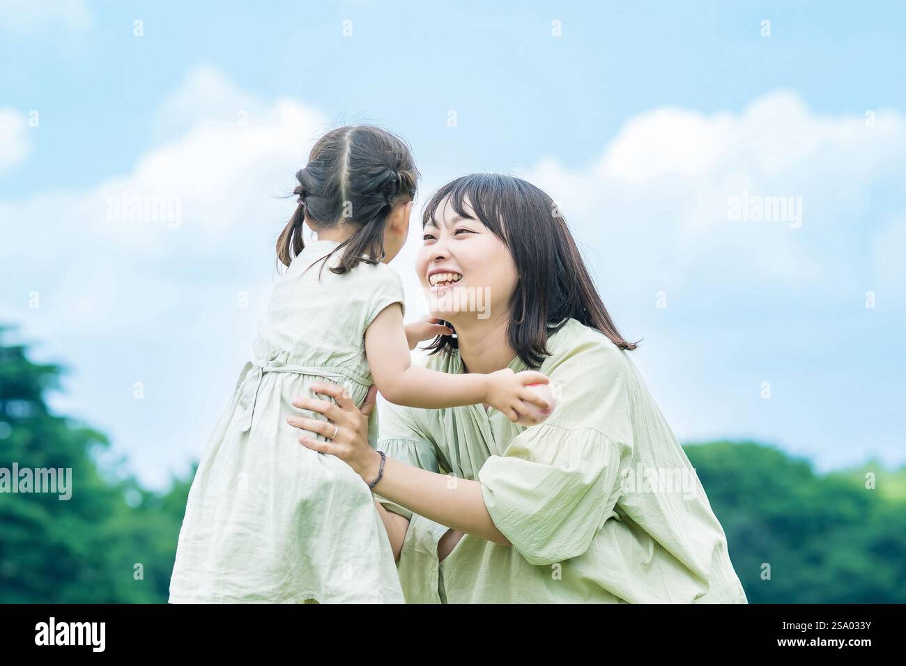 Parent and child hugging in the park Stock Photo - Alamy