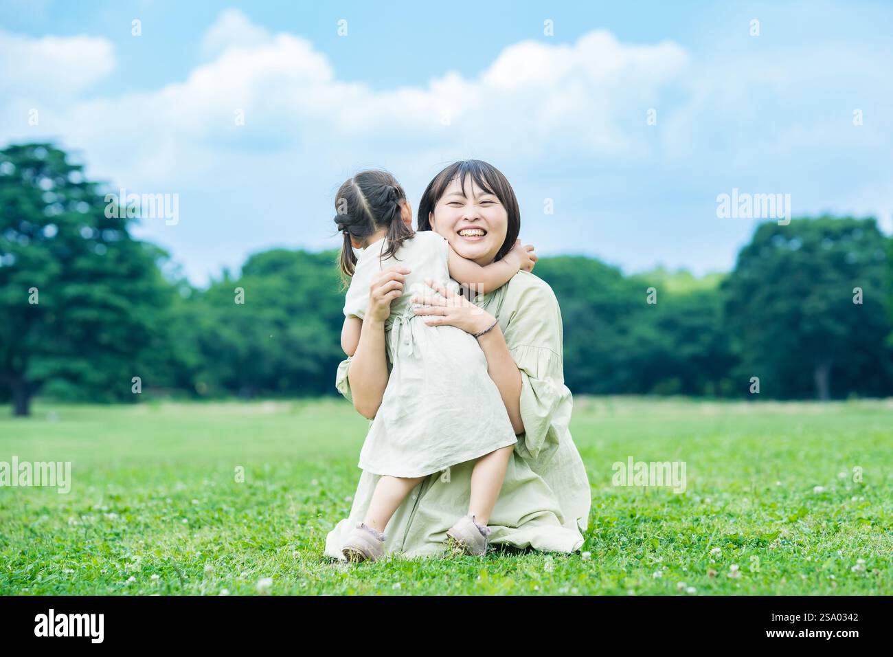 Parent and child hugging in the park Stock Photo - Alamy