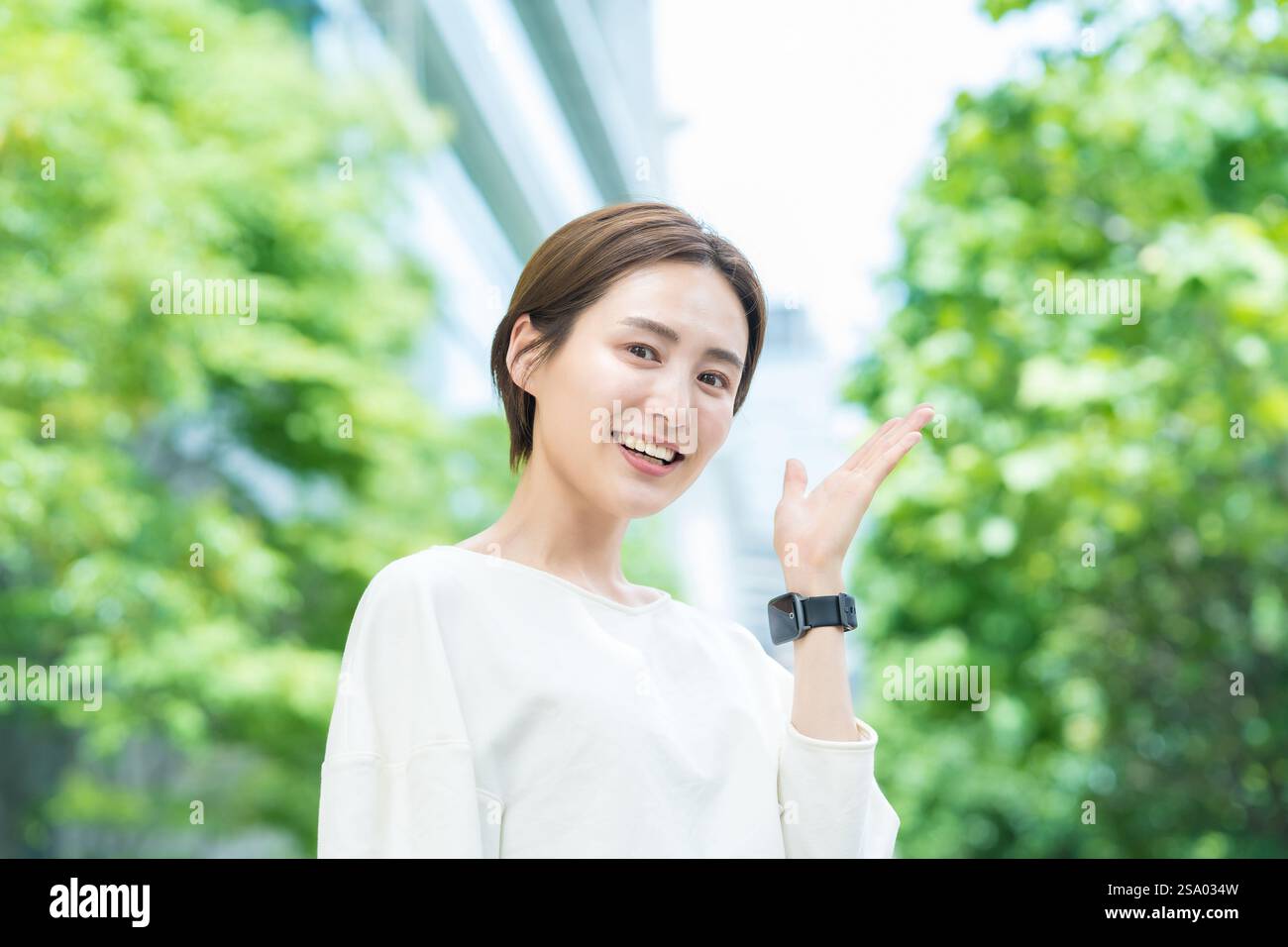 Woman striking a guiding pose Stock Photo - Alamy