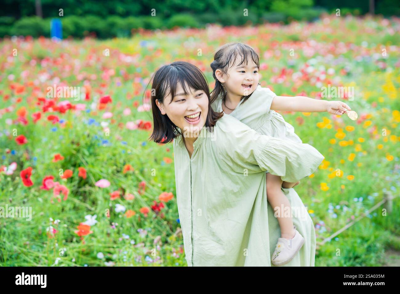 Parents and children strolling through flower garden Stock Photo - Alamy