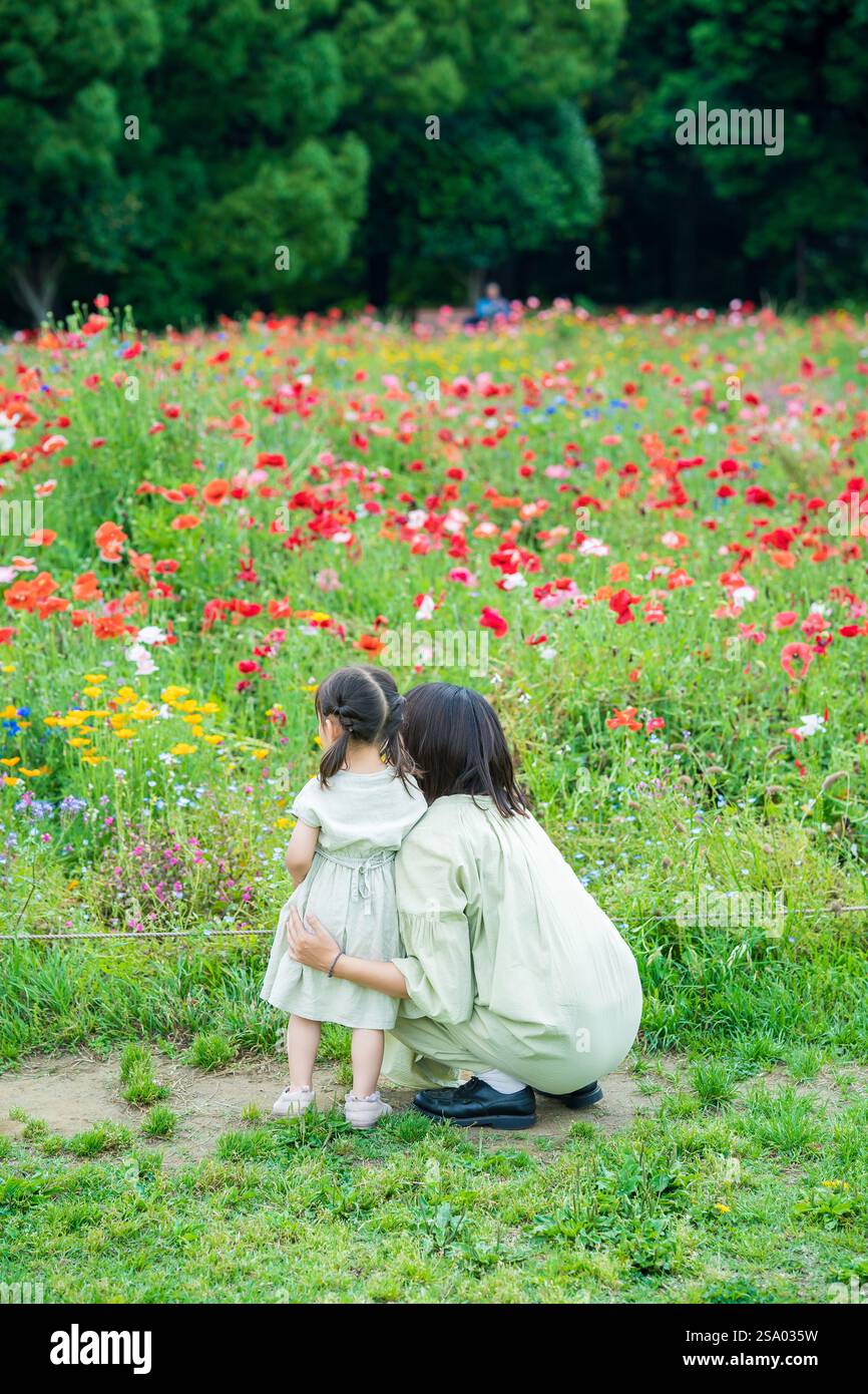 Parents and children strolling through flower garden Stock Photo - Alamy