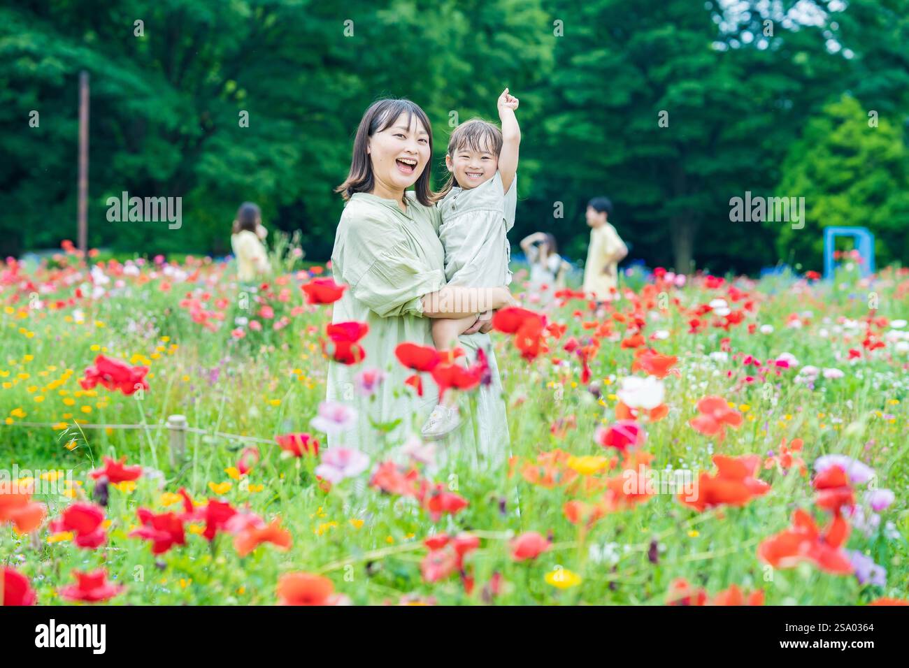 Parents and children strolling through flower garden Stock Photo - Alamy