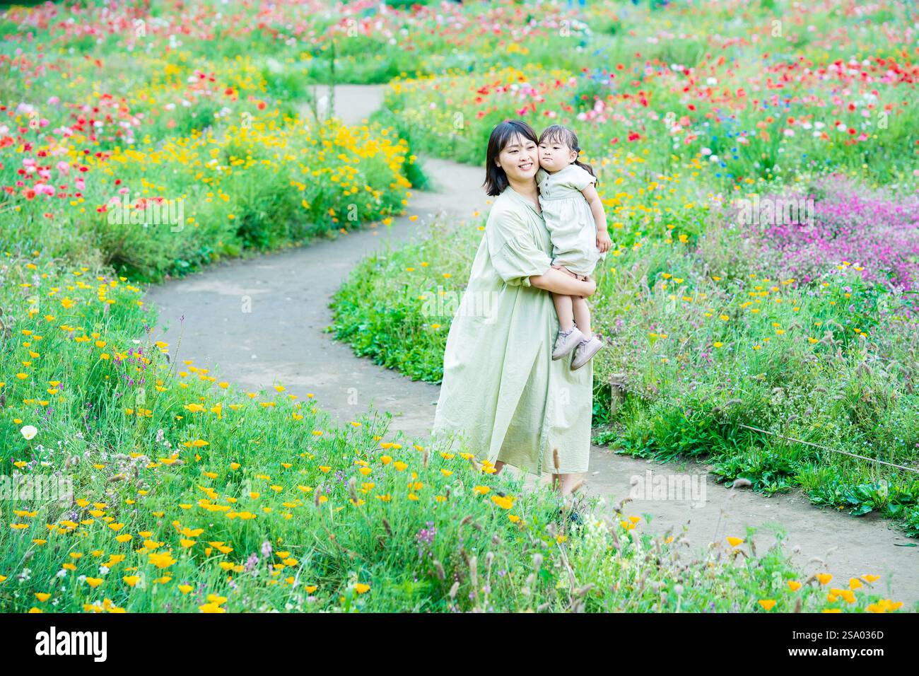 Parents and children strolling through flower garden Stock Photo - Alamy