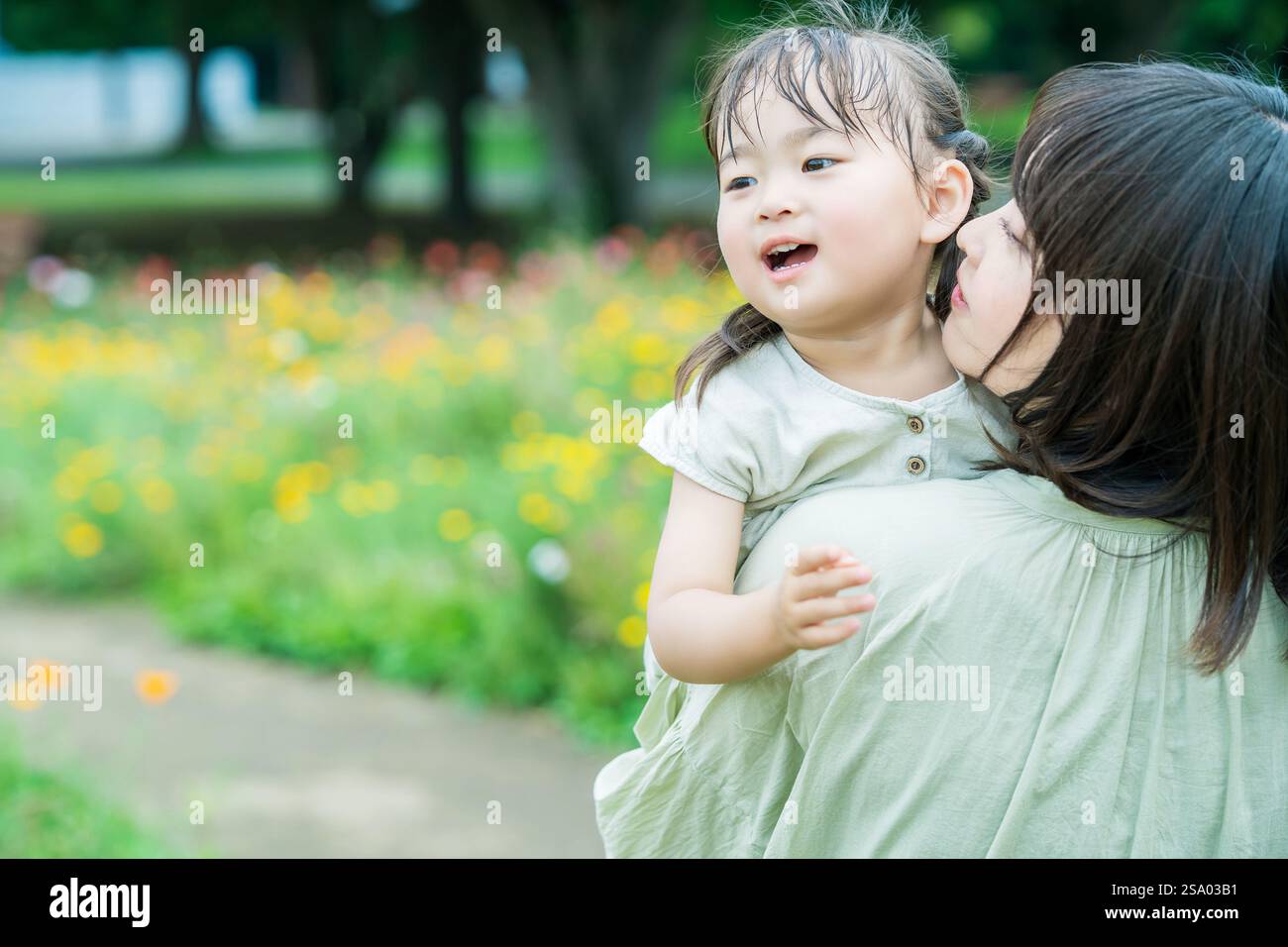 Parents and children strolling through flower garden Stock Photo - Alamy