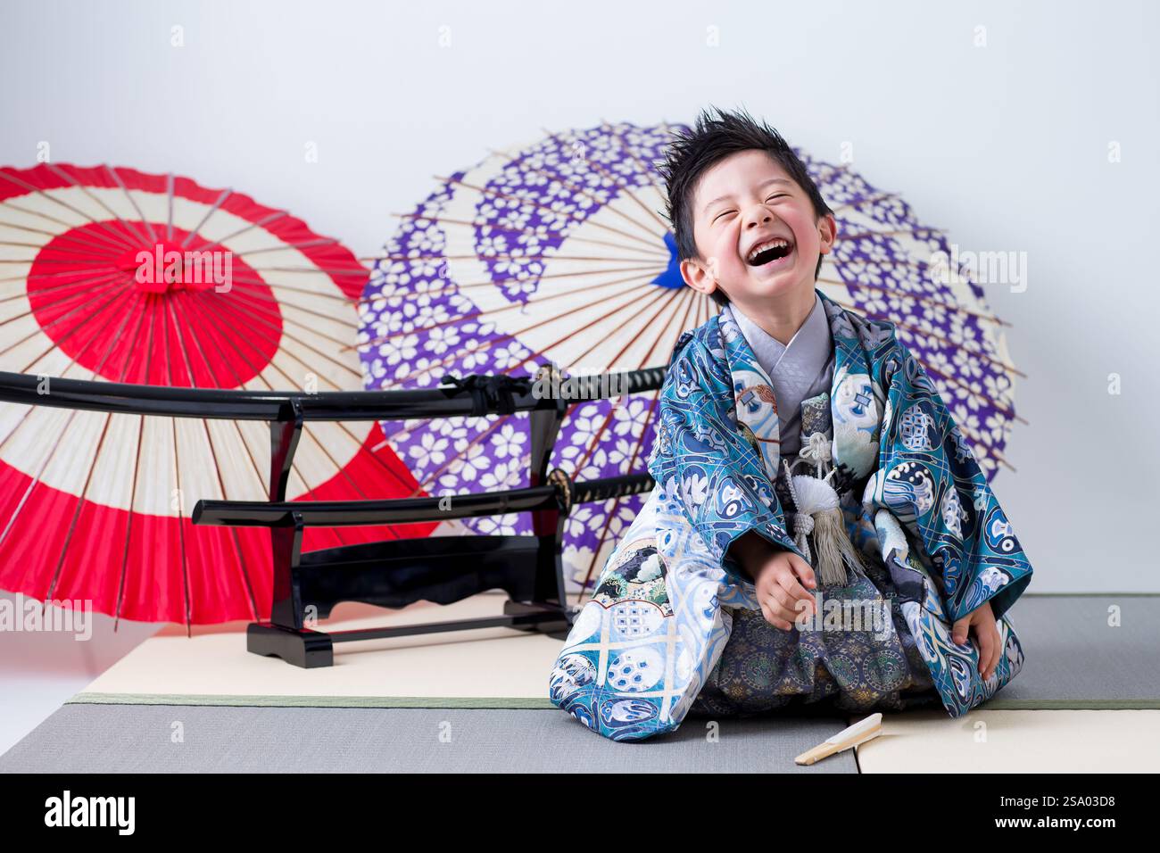 Boy sitting upright on tatami mat wearing kimono, SWORD Stock Photo - Alamy