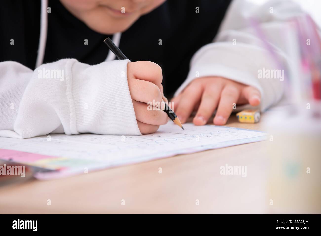 Child's hand solving a problem book Stock Photo - Alamy