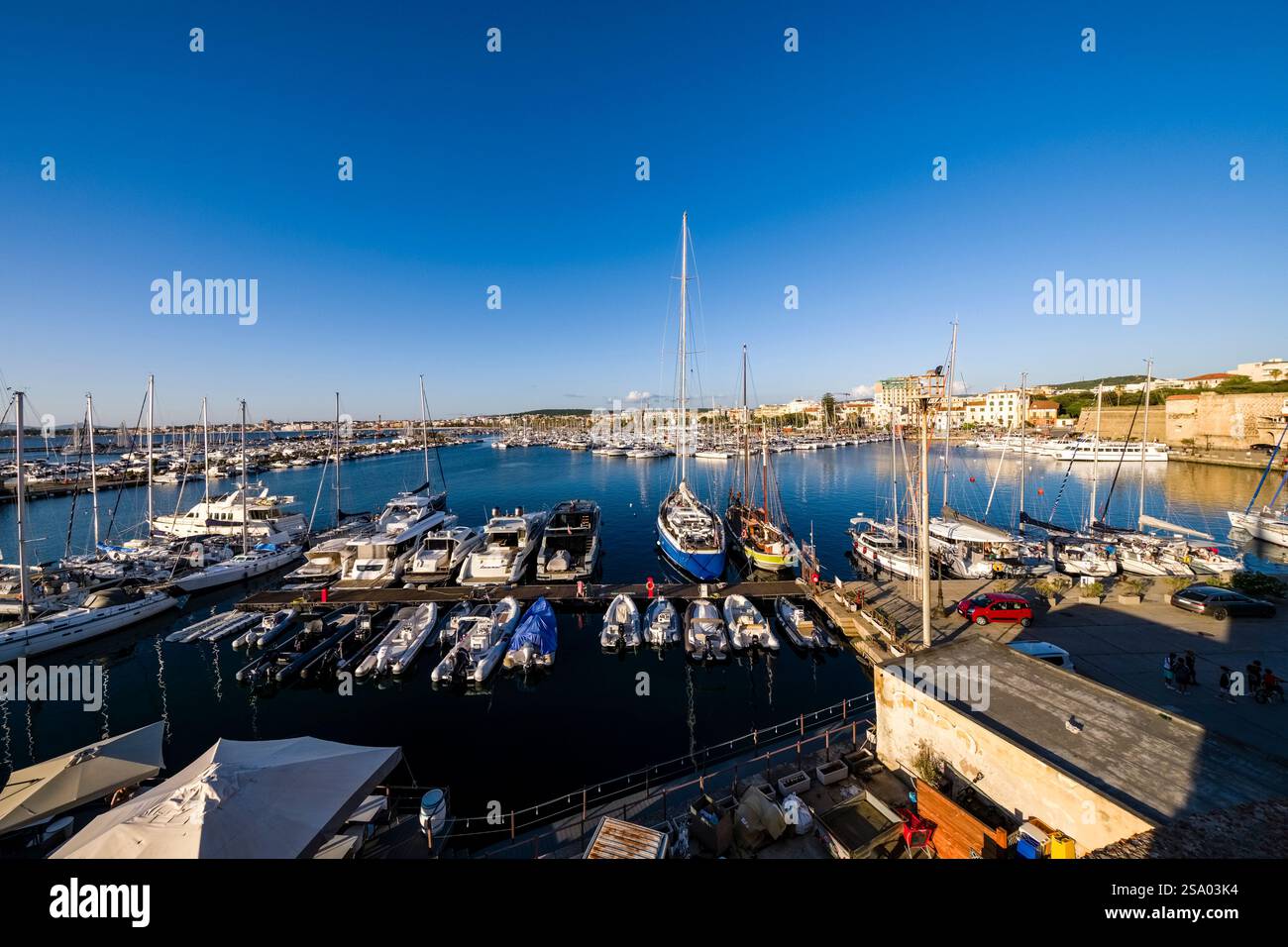 Aerial view of harbour and marina of Alghero with many boats anchored ...