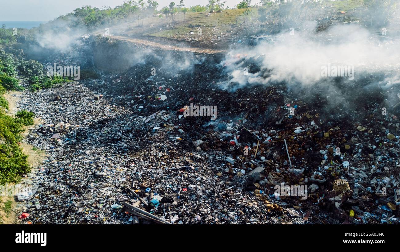 Burning landfill emitting smoke, highlighting environmental pollution ...