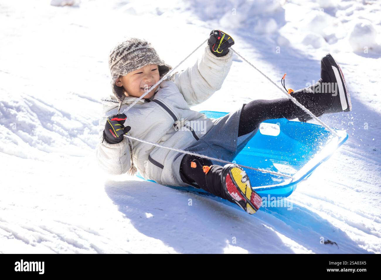 Kids sled on snow hi-res stock photography and images - Alamy