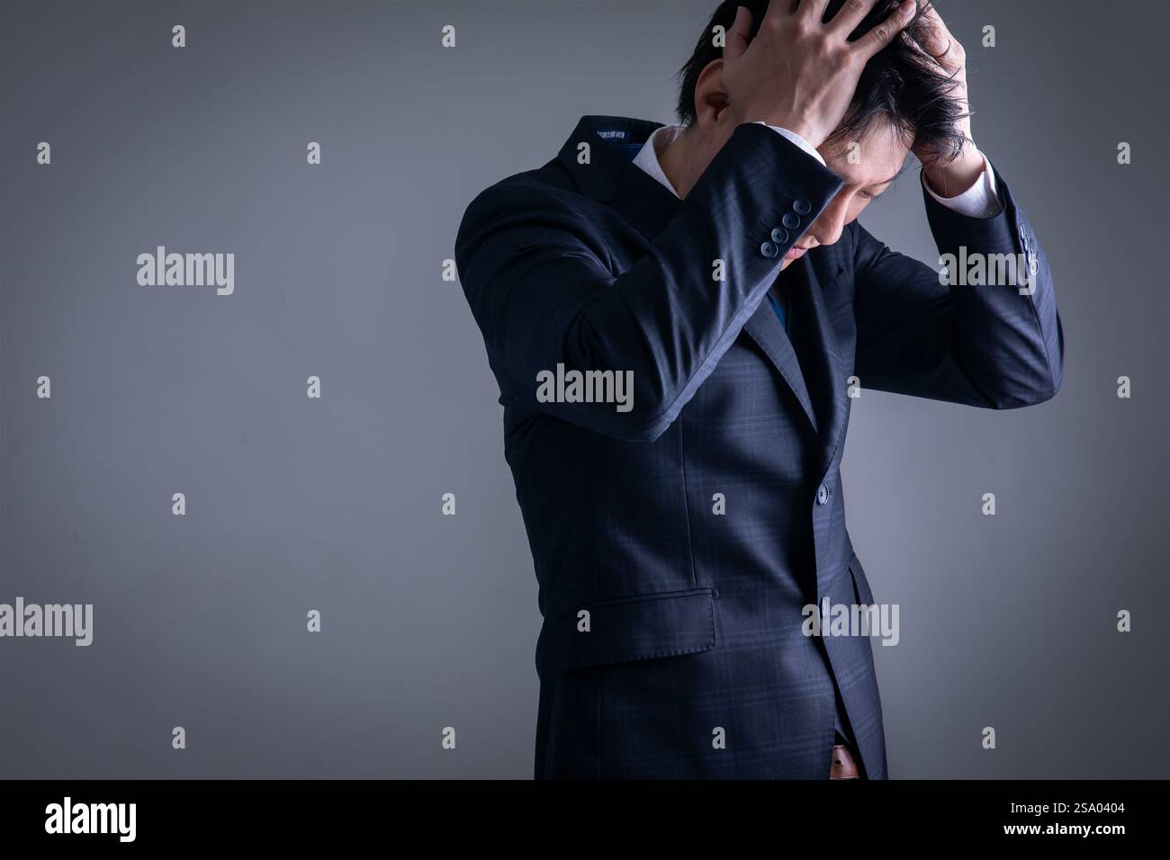 Man holding head, business Stock Photo - Alamy