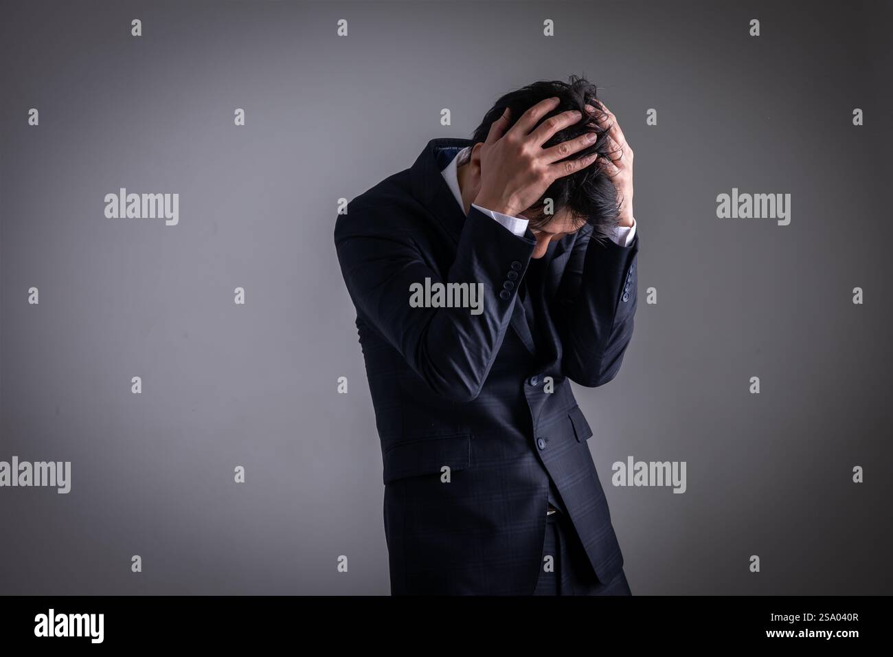 Distressed man holding his head Stock Photo - Alamy