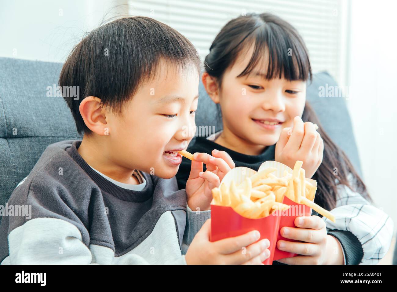 Child eating snack Stock Photo - Alamy