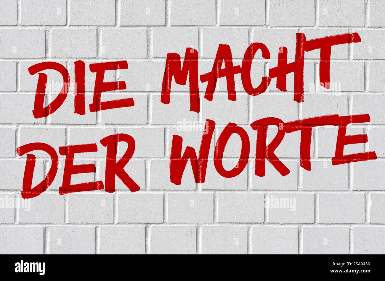 Graffiti on a brick wall - The power of words in german Stock Photo - Alamy