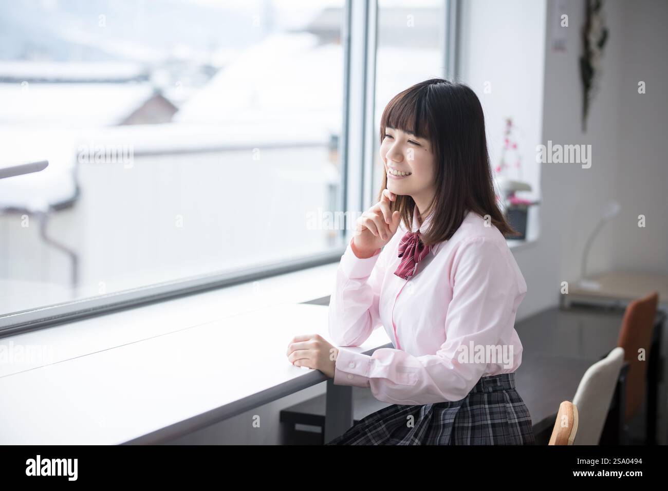 High school student looking out of classroom window Stock Photo - Alamy