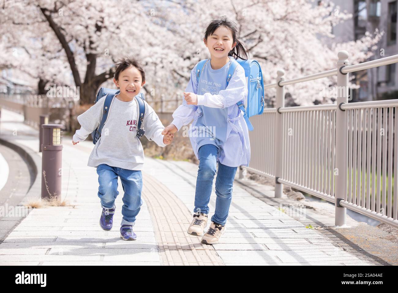 Primary school children walking hand in hand Stock Photo - Alamy