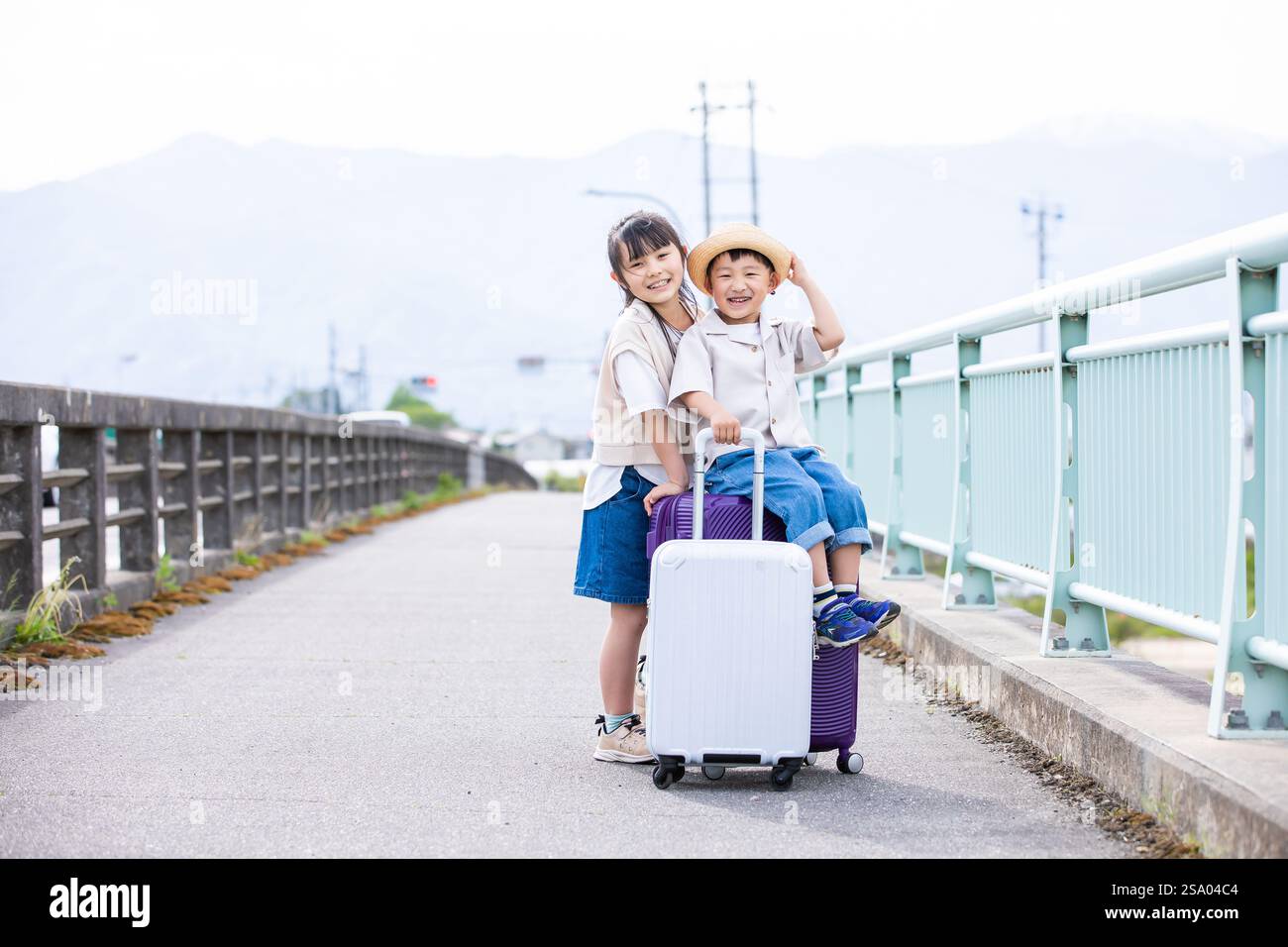 Boy pulling suitcase travel Stock Photo - Alamy