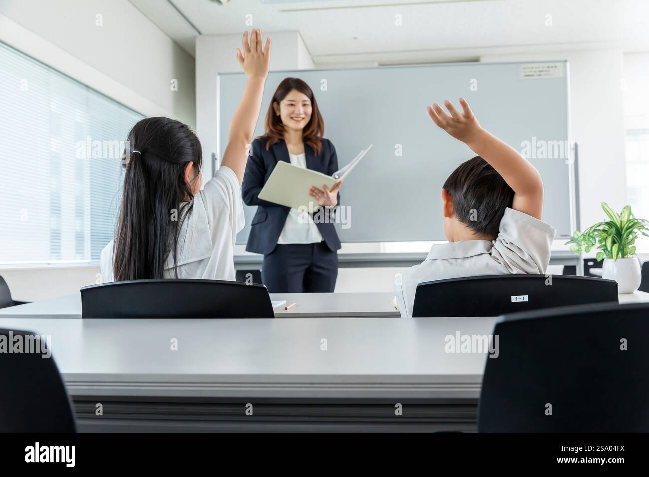 Primary schools student taking a class Stock Photo - Alamy