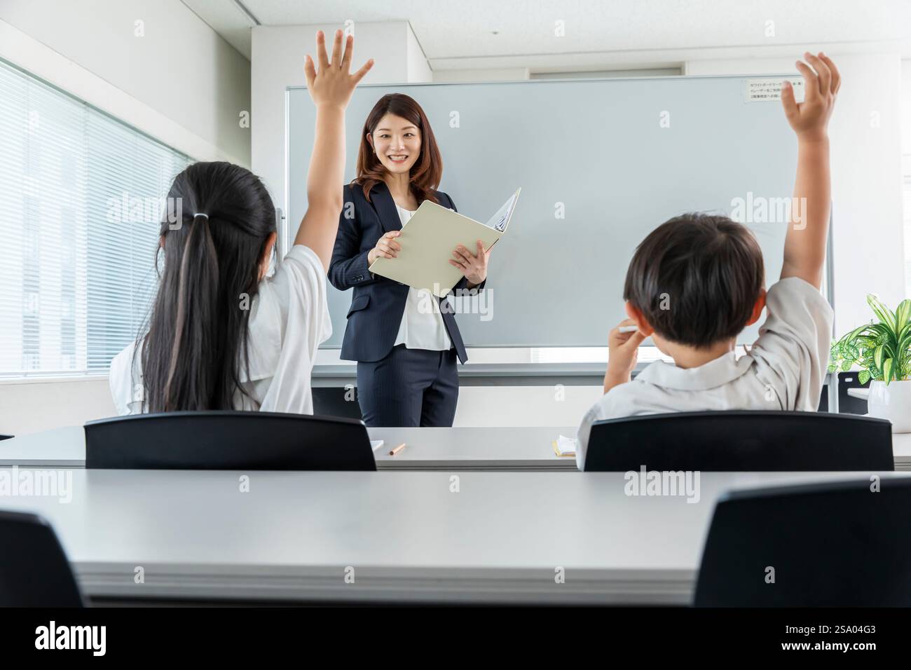 Primary schools student taking a class Stock Photo - Alamy