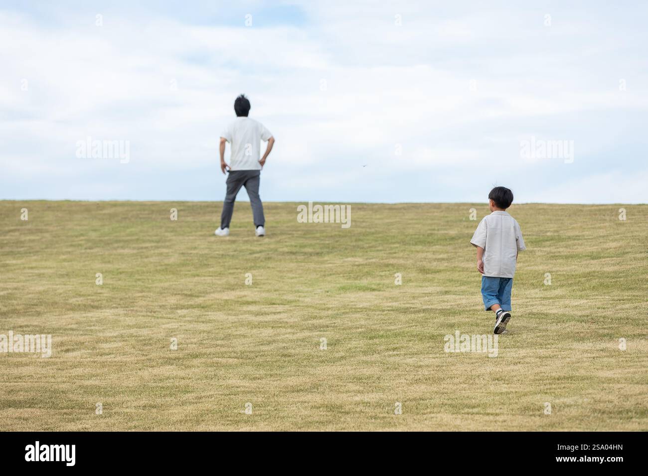 Son chasing father Stock Photo - Alamy