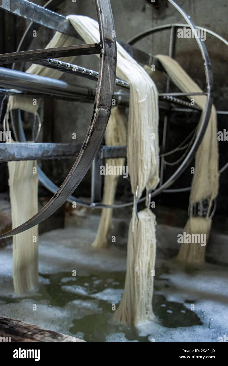 Workers with precision and care, skillfully wrap skeins of yarn around ...